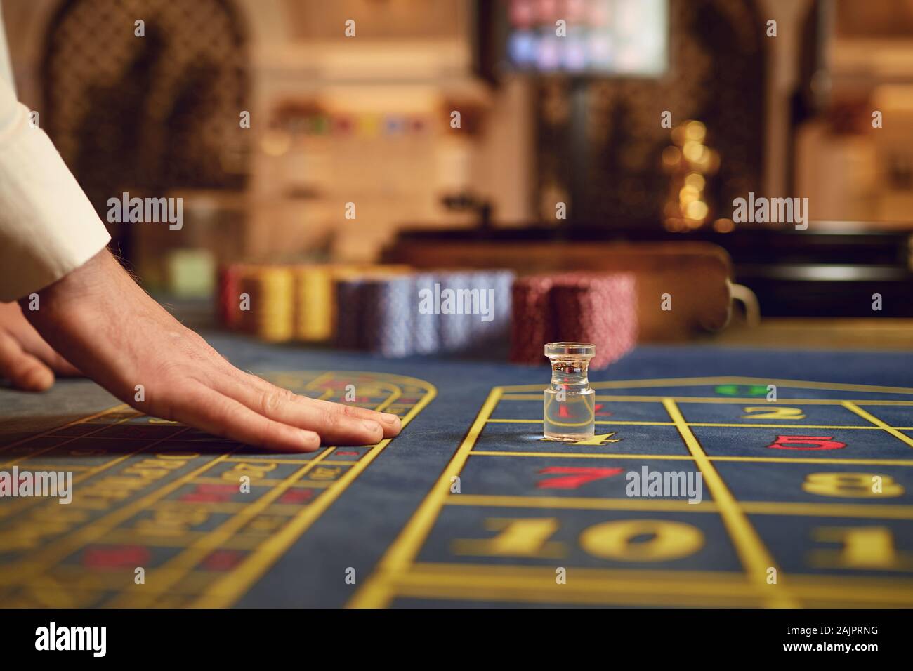 Croupier hand on the roulette table Stock Photo - Alamy