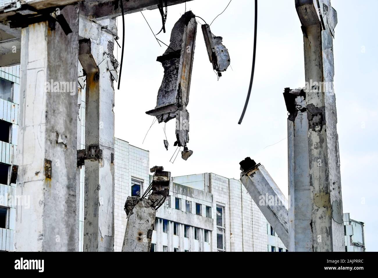 Remains of the destroyed industrial building. Large concrete piles with ...