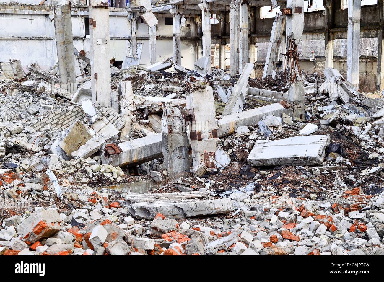 The remains of a large destroyed building with concrete pilings and ...