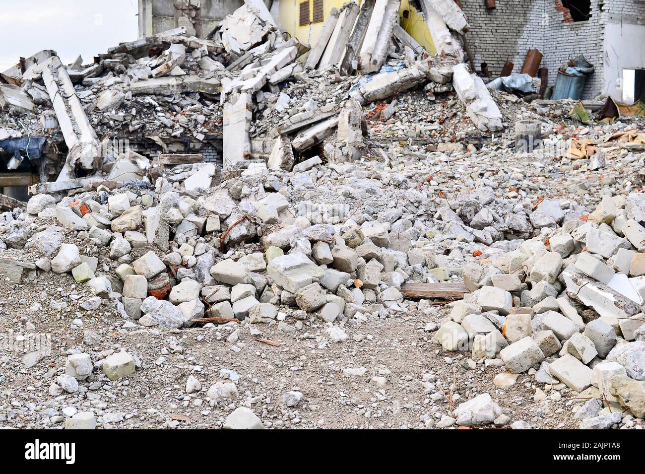 The ruined remains of a large industrial facility. Pile of rocks in the ...