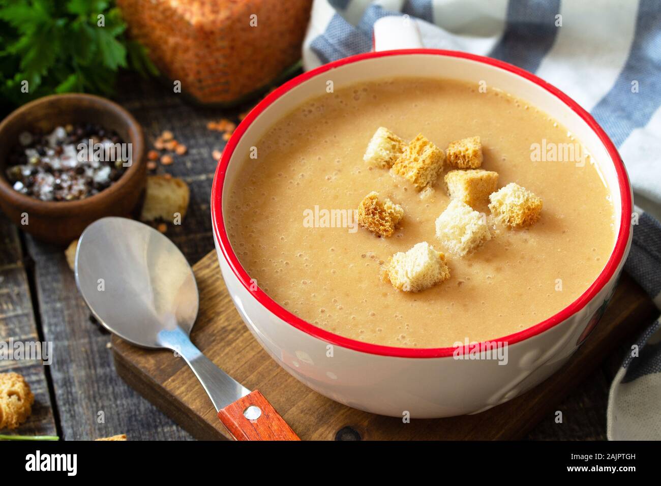 Oriental or Arabic cuisine. Hot lentil puree soup on a rustic wooden ...