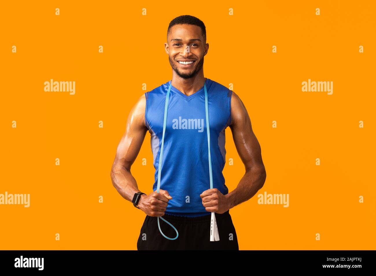 Workout Concept. Happy black man with jumping rope on neck isolated ...