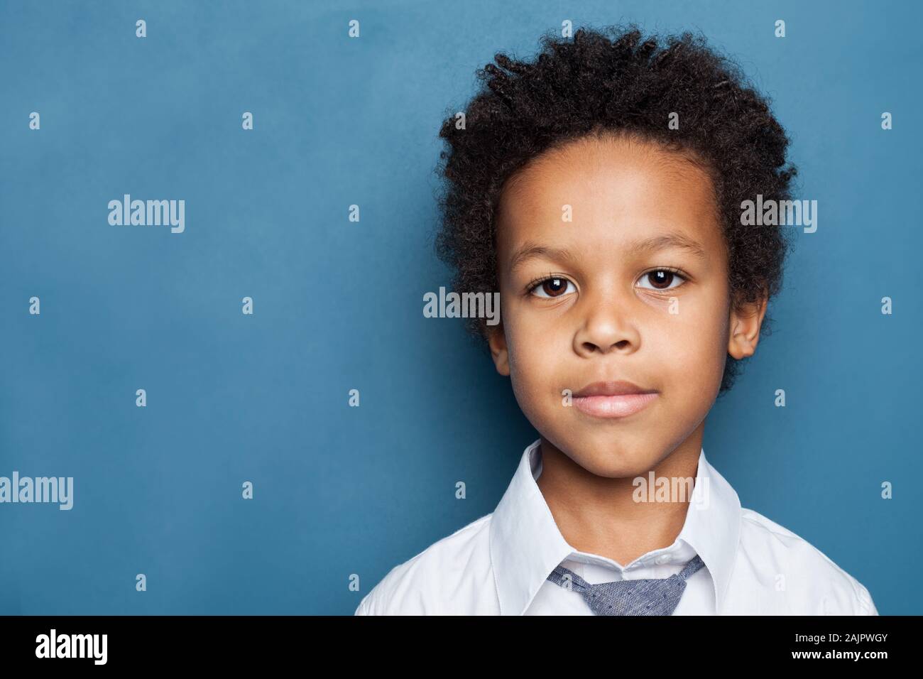 Child boy face on blue background Stock Photo - Alamy