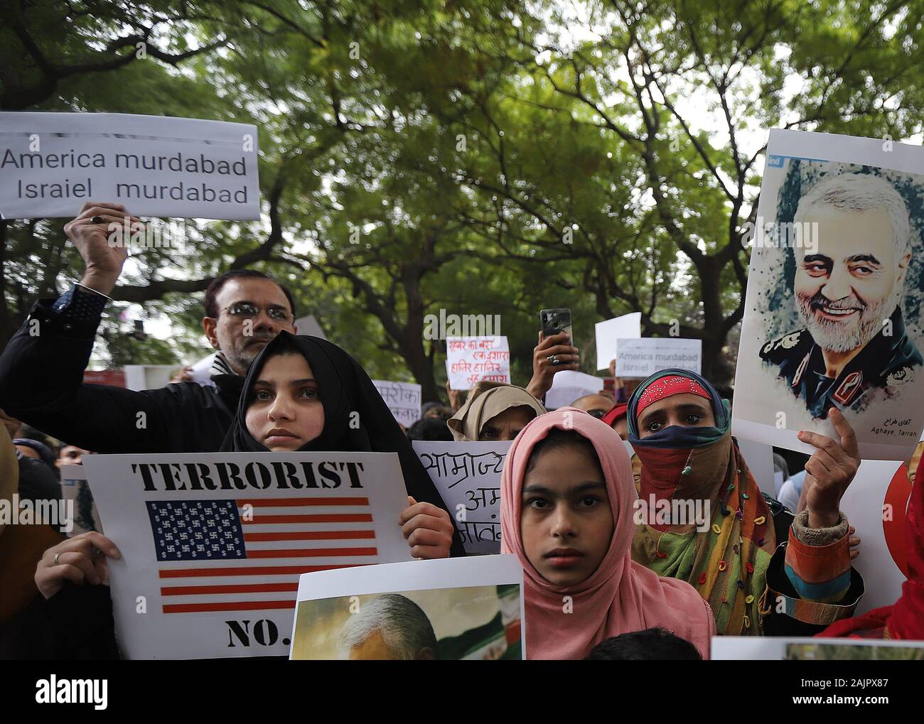 Shia Muslim community people hold portraits and placards during the ...