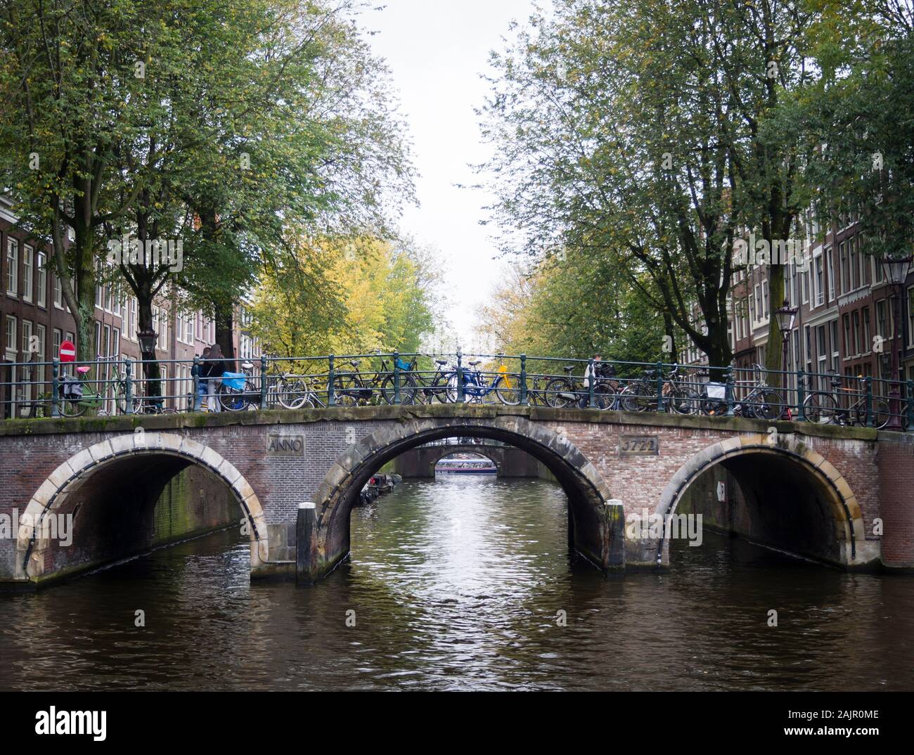 Parked bicycles on an old Amsterdam canal bridge across Reguliersgracht ...