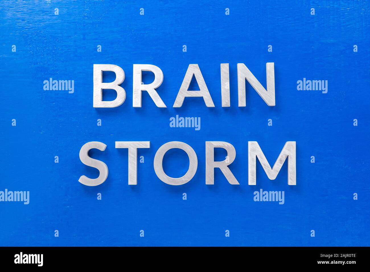the phrase brain storm laid with silver metal letters on blue board in ...
