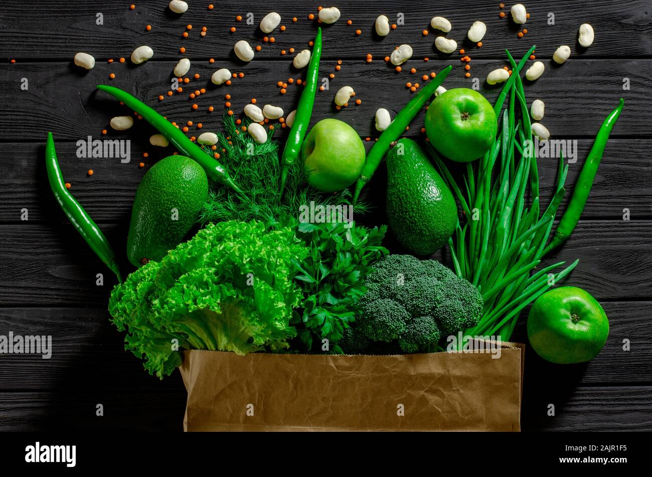 Zero waste concept. Paper bag with various green vegetables top view ...