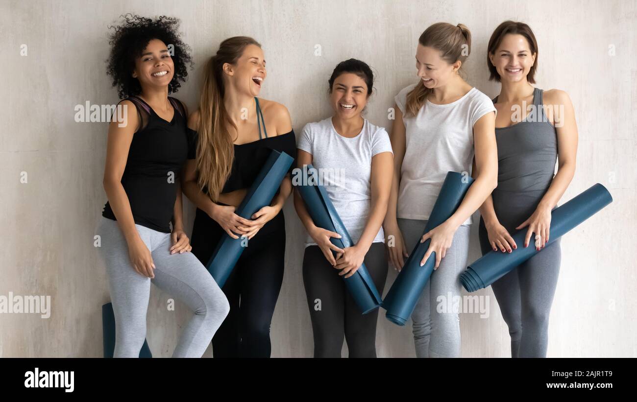 Beautiful diverse women with yoga mats posing for portrait Stock Photo ...