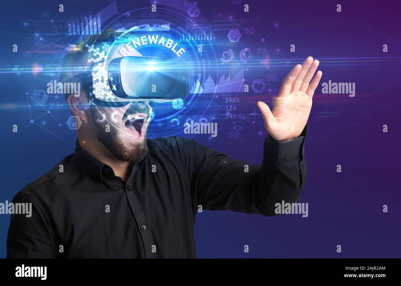 Businessman looking through Virtual Reality glasses with RENEWABLE ...