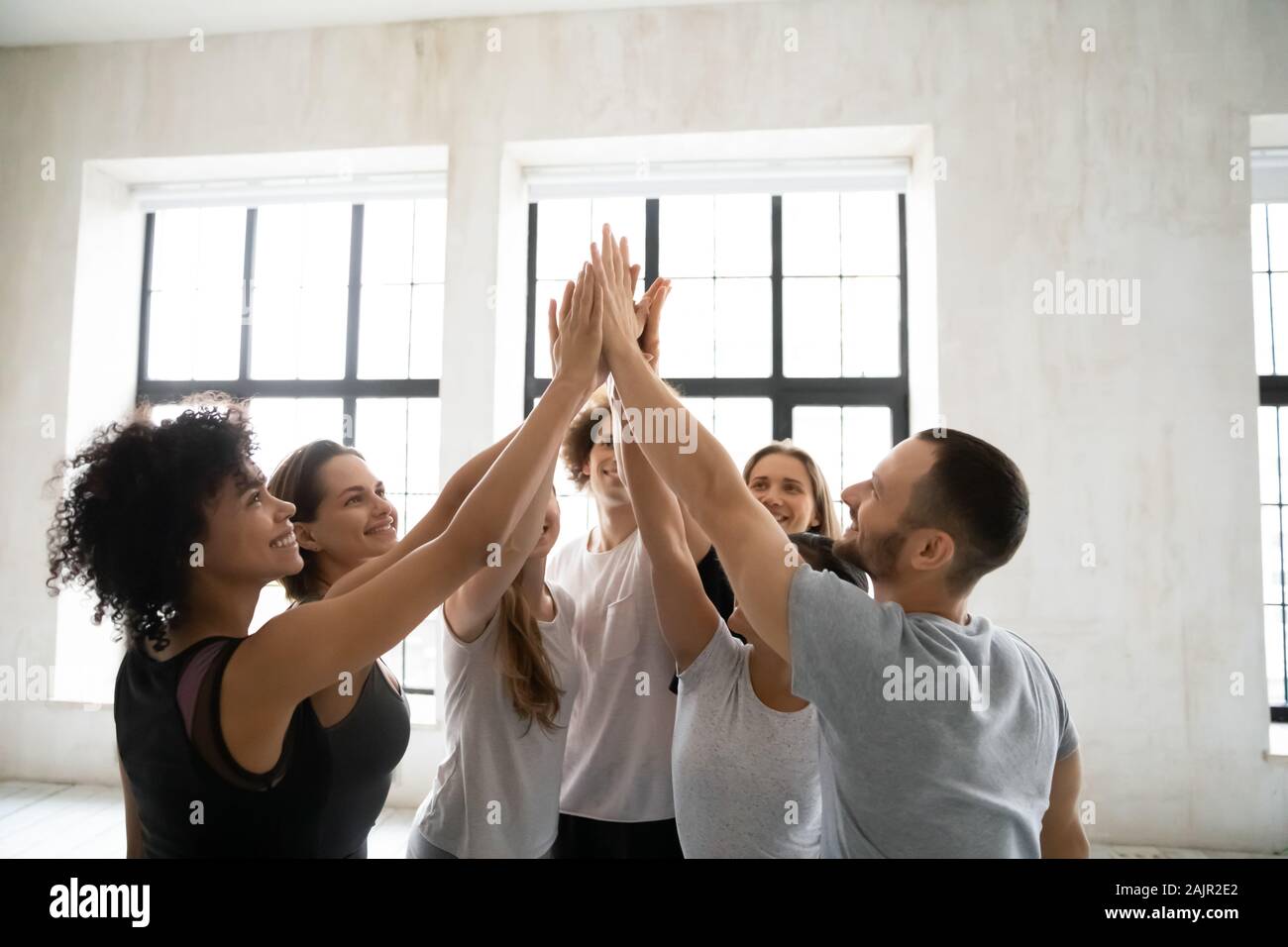 Happy smiling diverse people sharing success, giving high five Stock ...