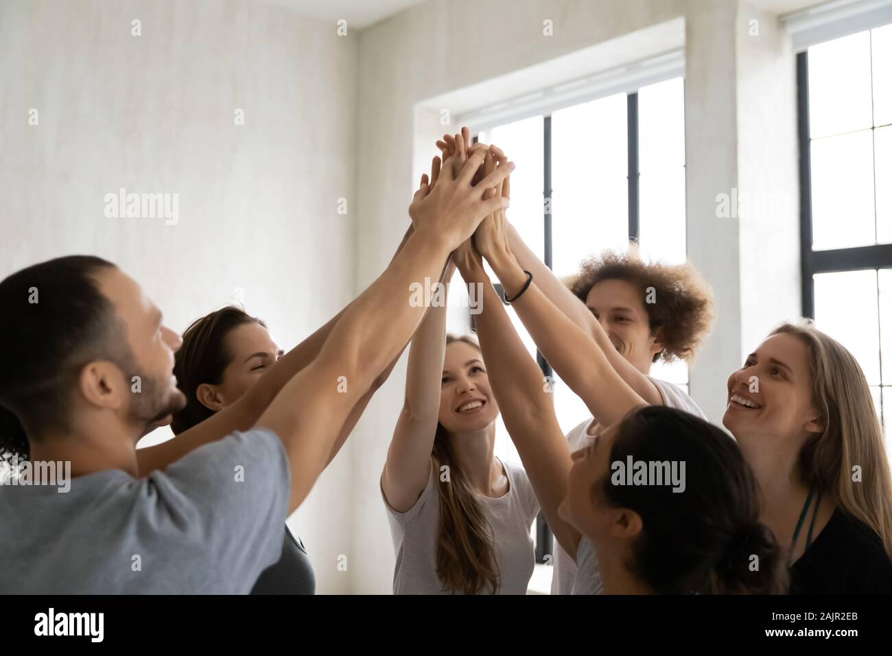 Successful team diverse people giving high five, sharing success Stock ...