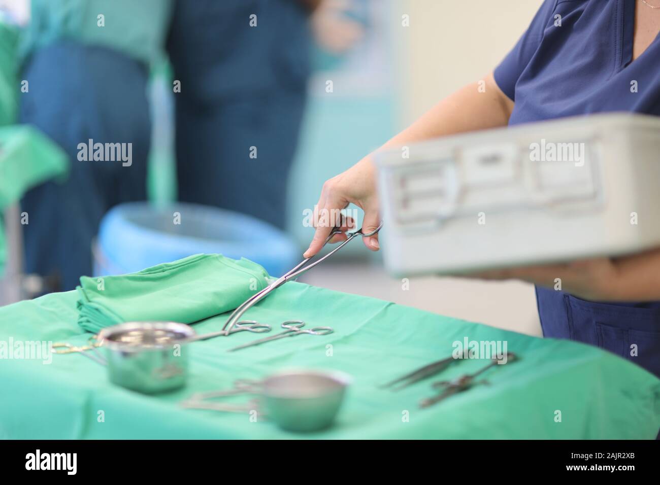 The nurse collects the surgical instrument in a special box after the ...