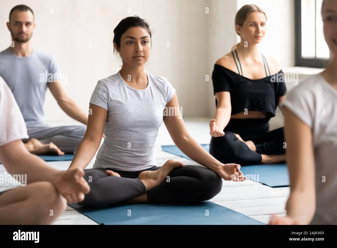 Beautiful Indian woman doing Padmasana exercise, practicing yoga Stock ...