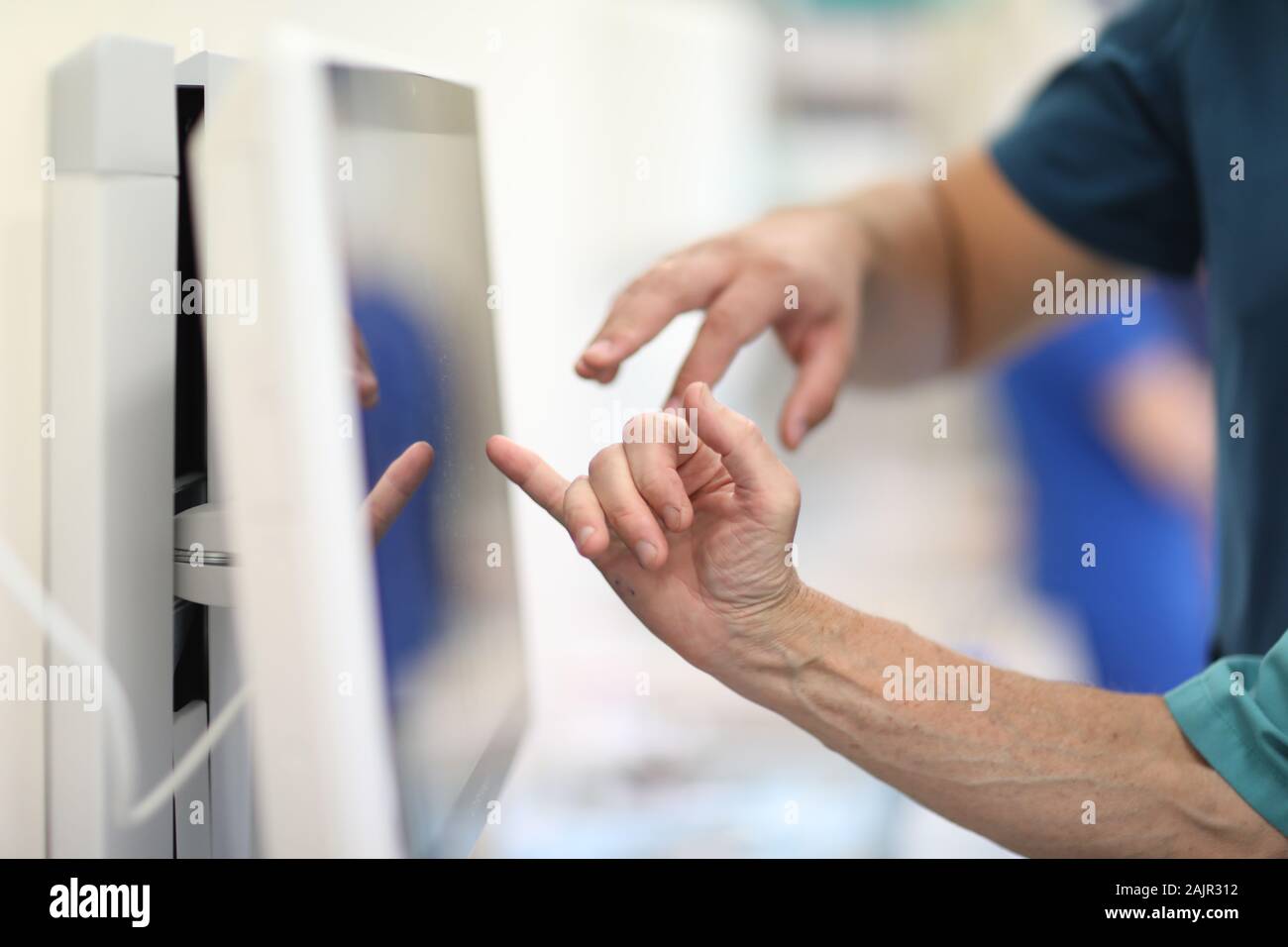 Doctors study and discuss information on the computer screen in the ...