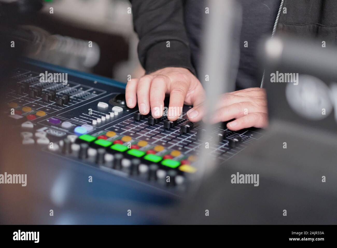 The sound engineer's hands on the mixing console during the concert ...