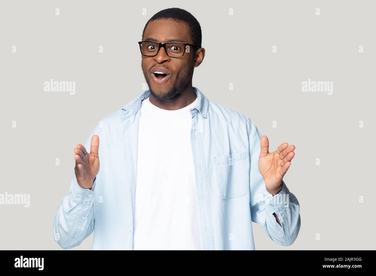 African guy stretched hands showing something long studio shot Stock ...