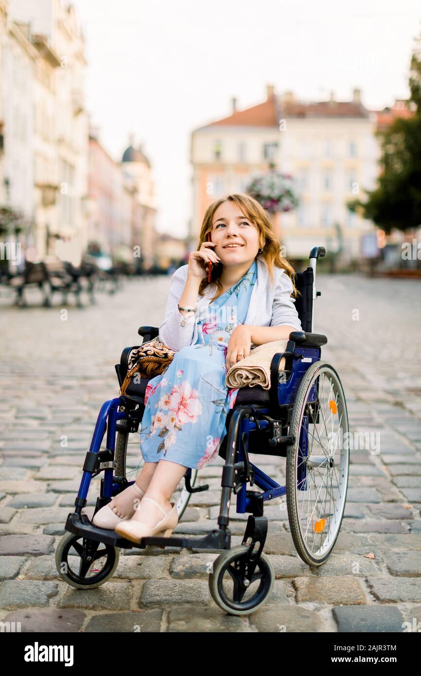 Portrait of a gorgeous young blond woman in a wheelchair enjoying her ...