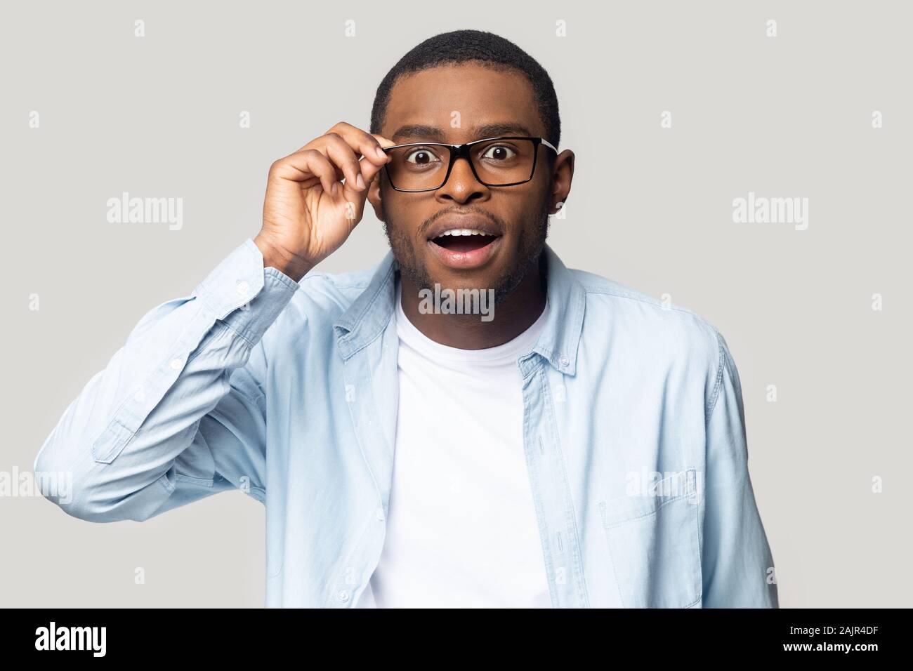 African guy staring at camera cant believe his eyes Stock Photo - Alamy