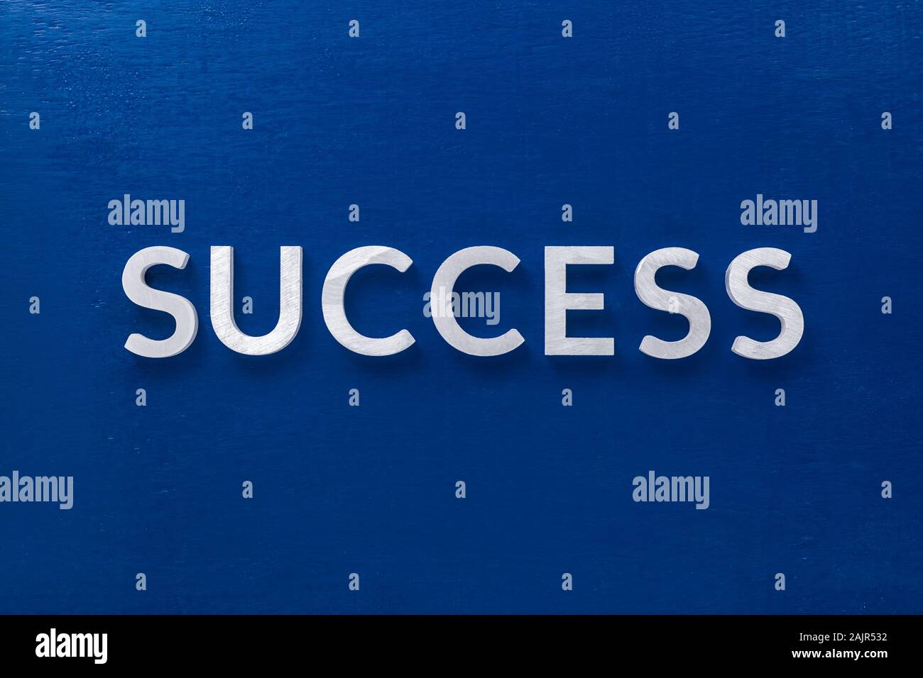 the laid with silver metal letters on classic blue board in flat lay ...