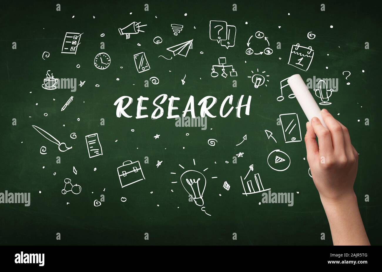 Hand drawing RESEARCH inscription with white chalk on blackboard ...