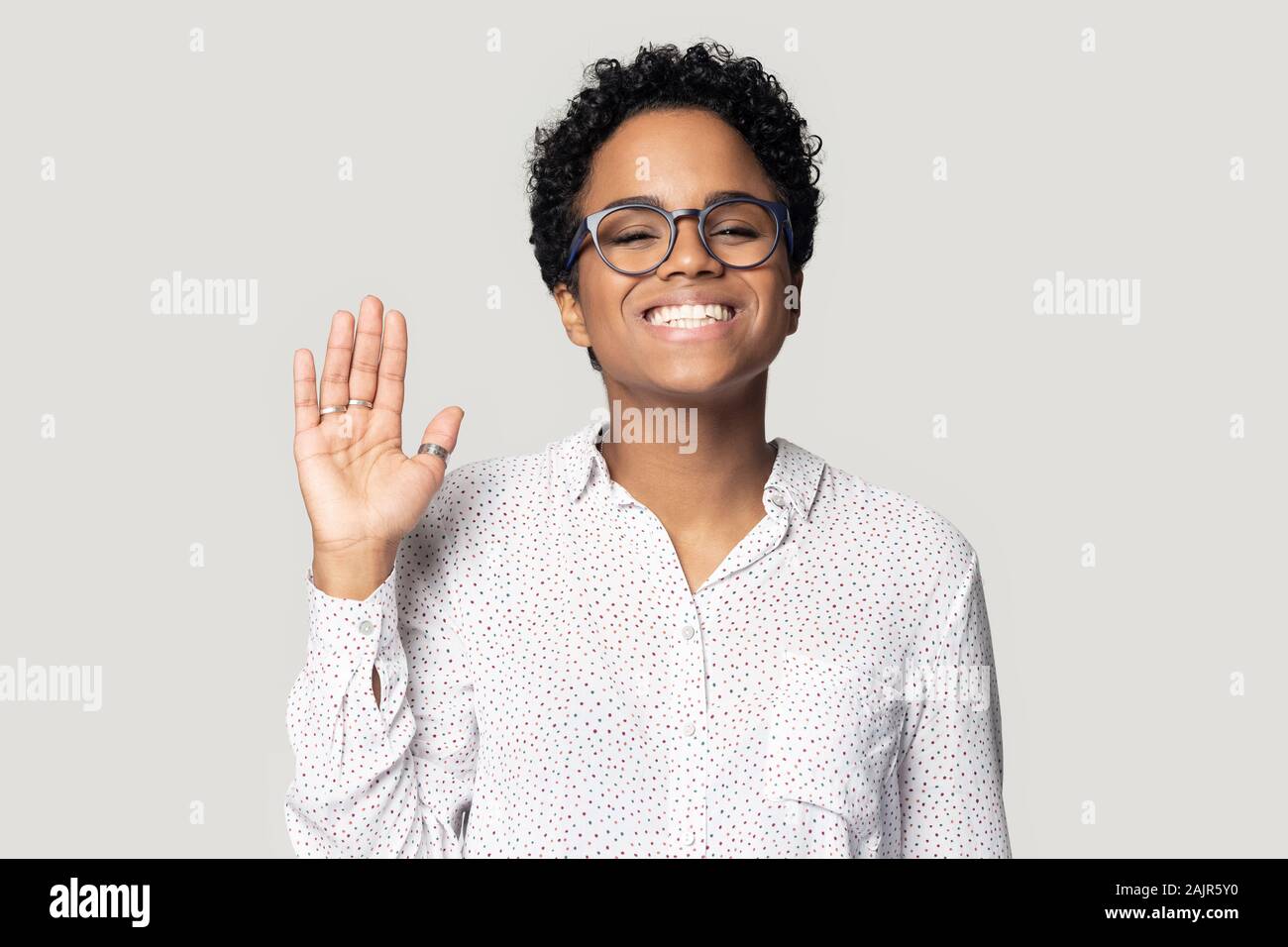African woman wave hand makes gesture of greeting studio shot Stock ...