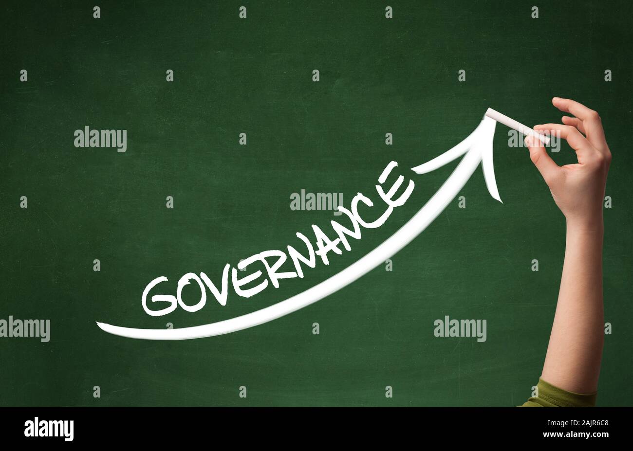 Hand drawing GOVERNANCE inscription with white chalk on blackboard ...