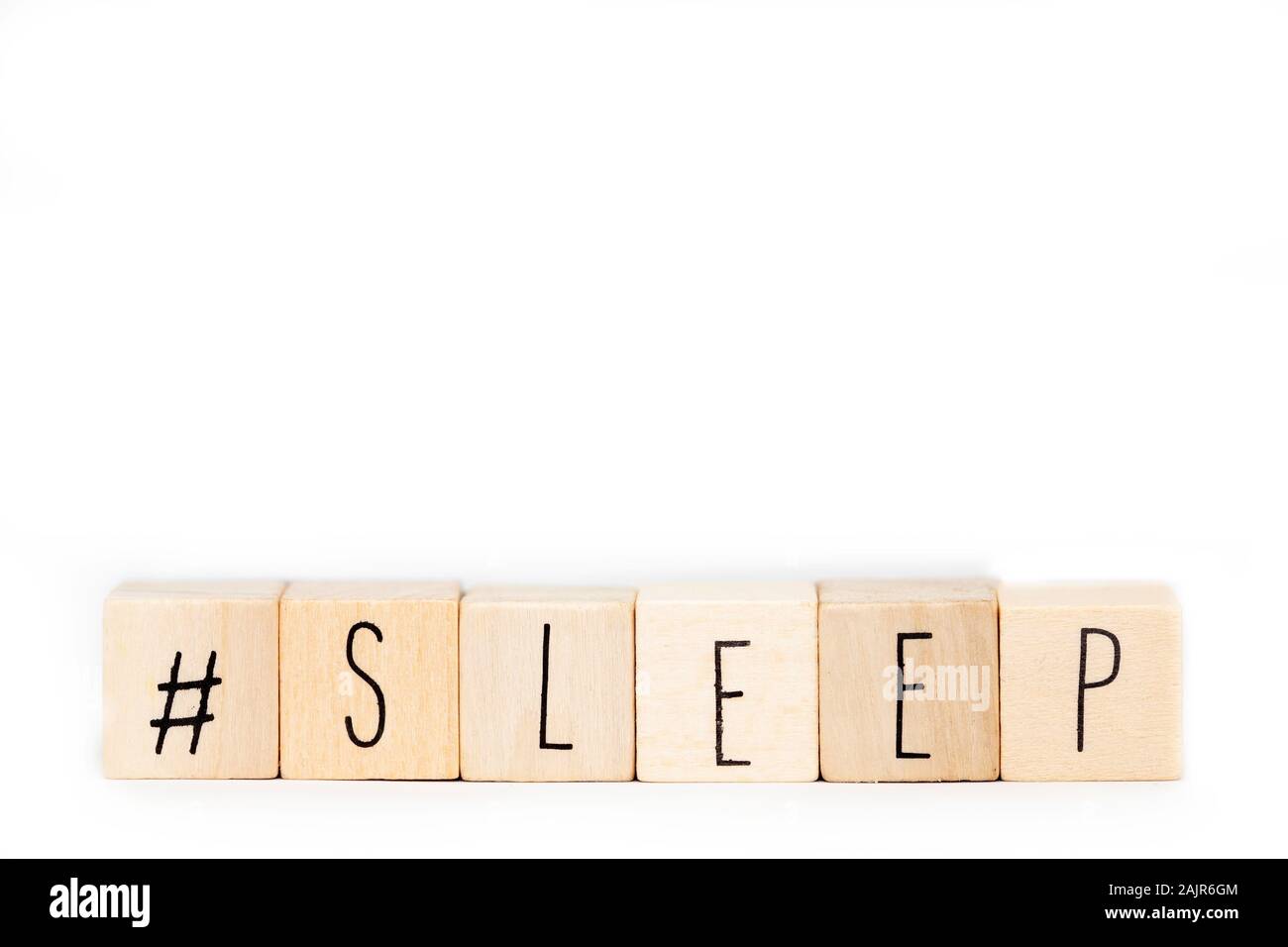 Wooden cubes with a Hashtag and the word Sleep isolated on white ...