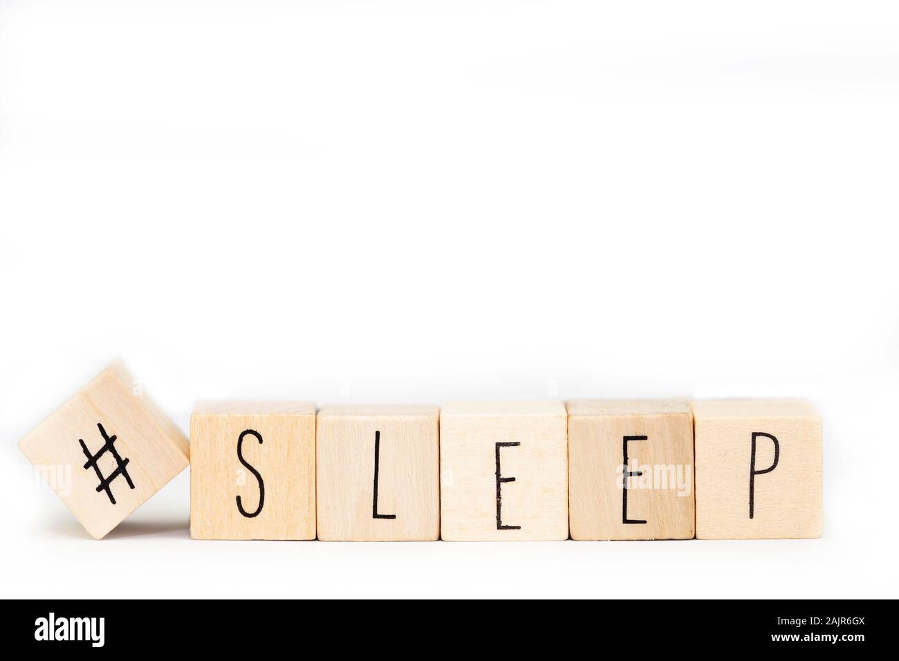 Wooden cubes with a Hashtag and the word Sleep isolated on white ...