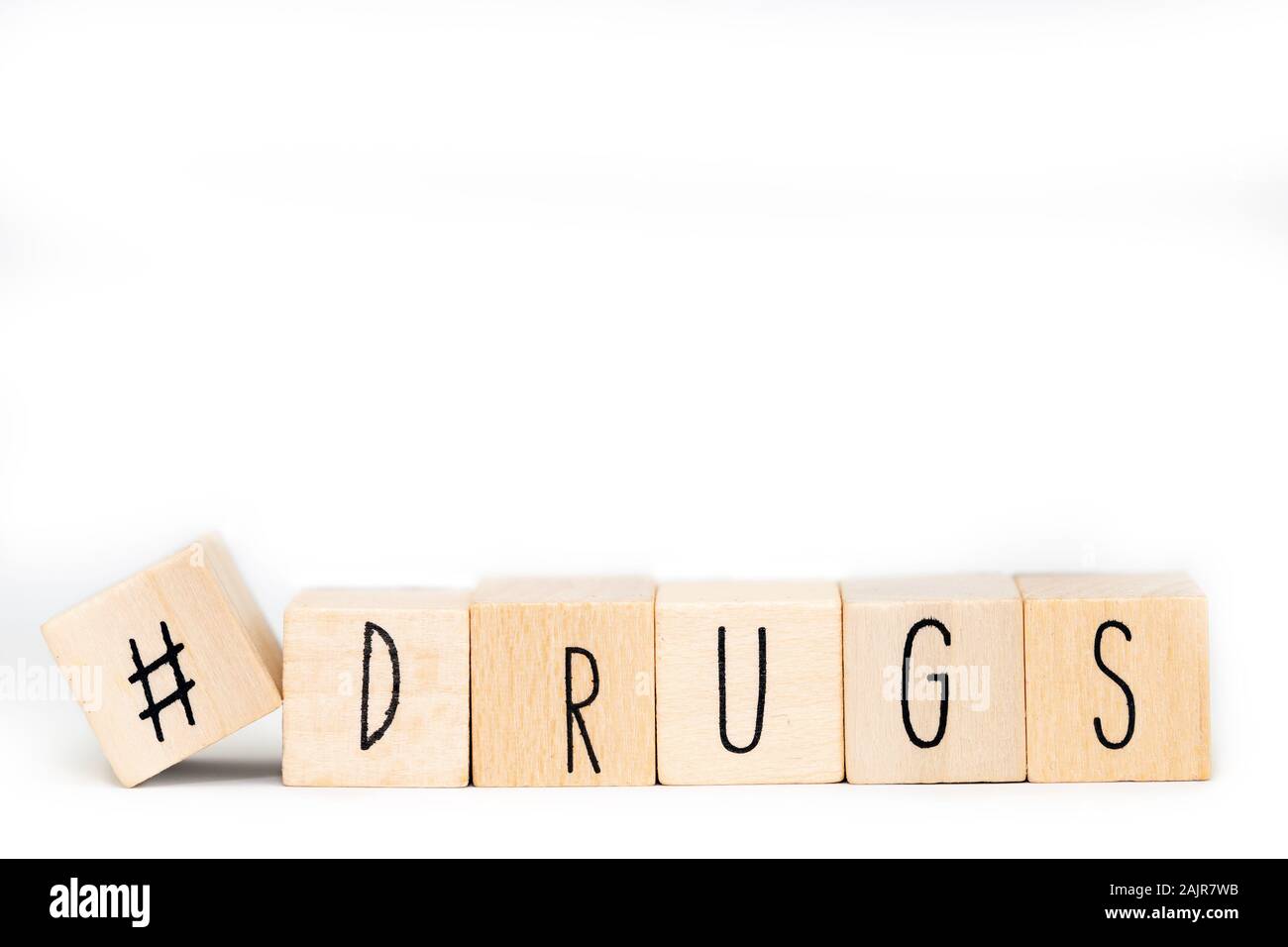 Wooden cube with a hashtag and the word Drugs isolated on white ...