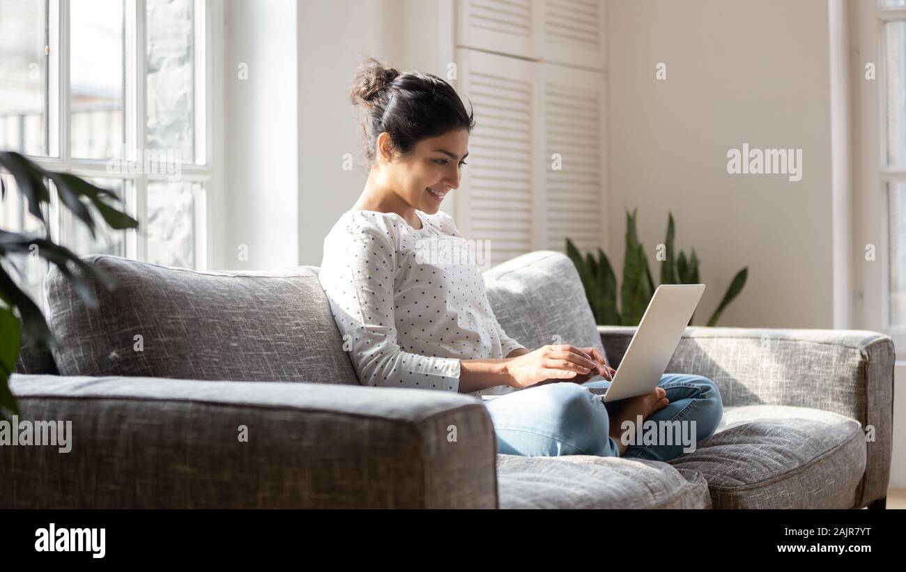 Happy indian girl using modern laptop at home Stock Photo - Alamy