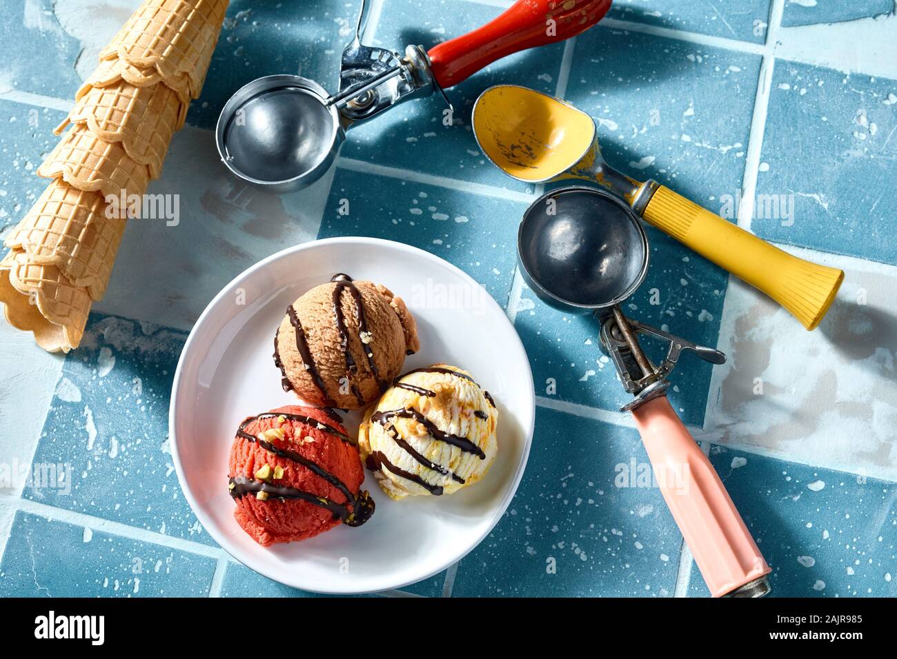 Serving of different flavored ice cream with three scoops and cornets ...