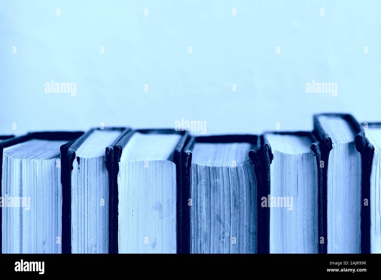 Old books standing in a row on white background, back to school concept ...