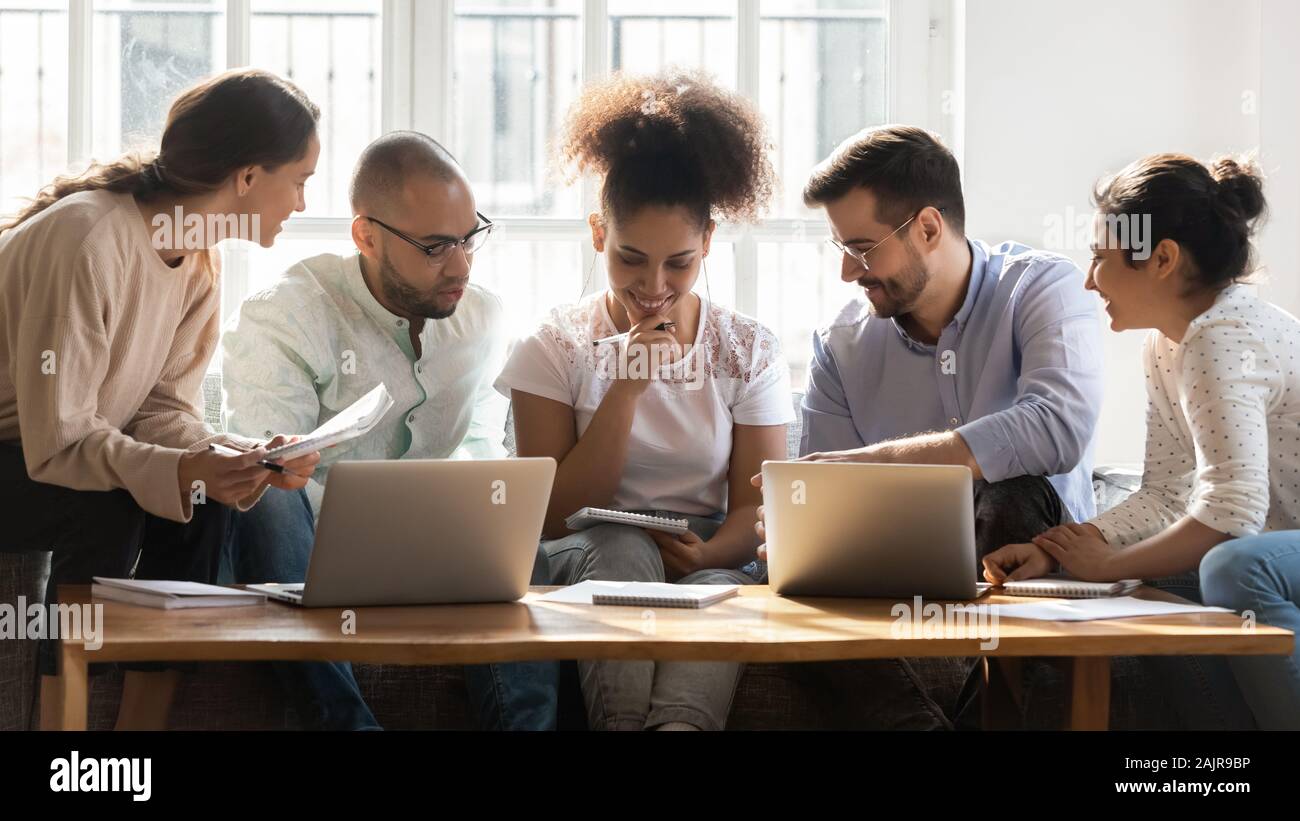Multiracial millennial students brainstorm studying together at home ...
