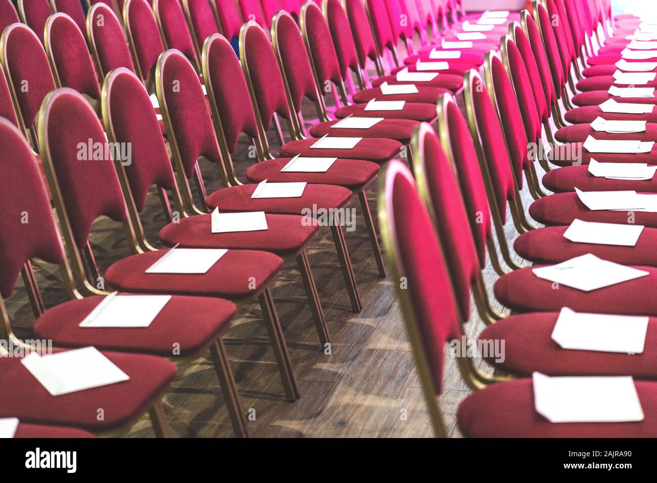 Rows of red chairs in conference hall, empty meeting or event room ...