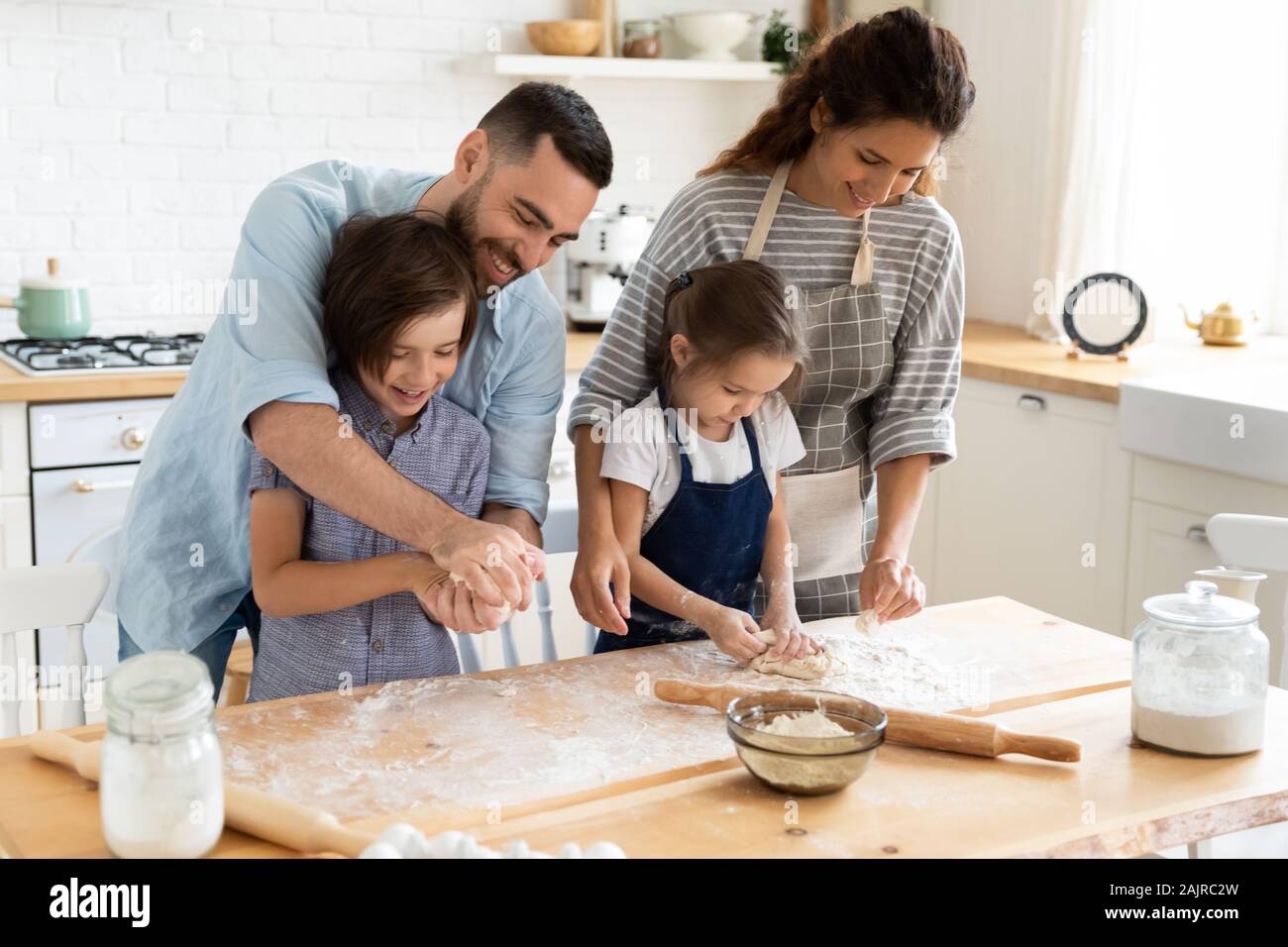 Family feels happy cooking family recipe pie together in kitchen Stock ...