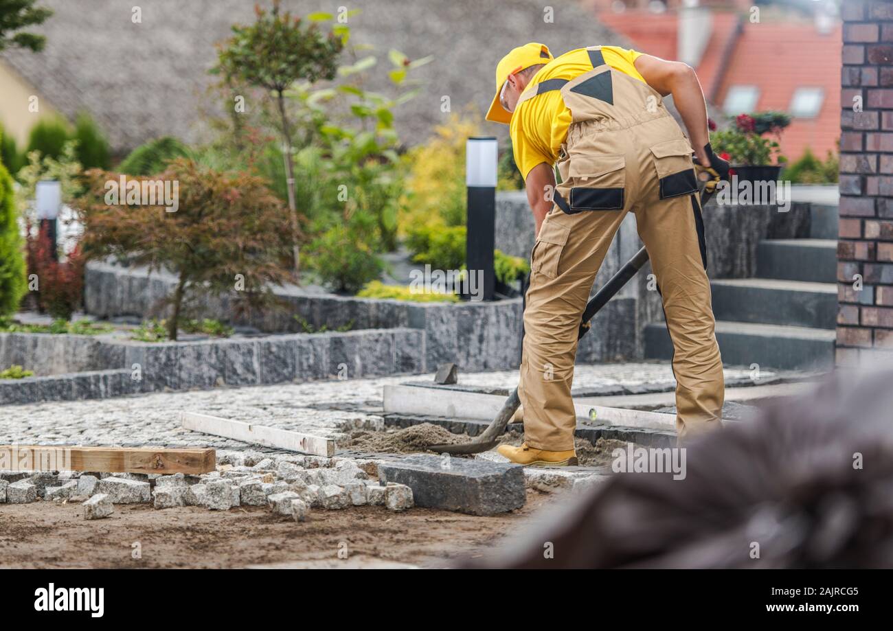 Granite Brick Paving Job. Caucasian Construction Industry Worker ...