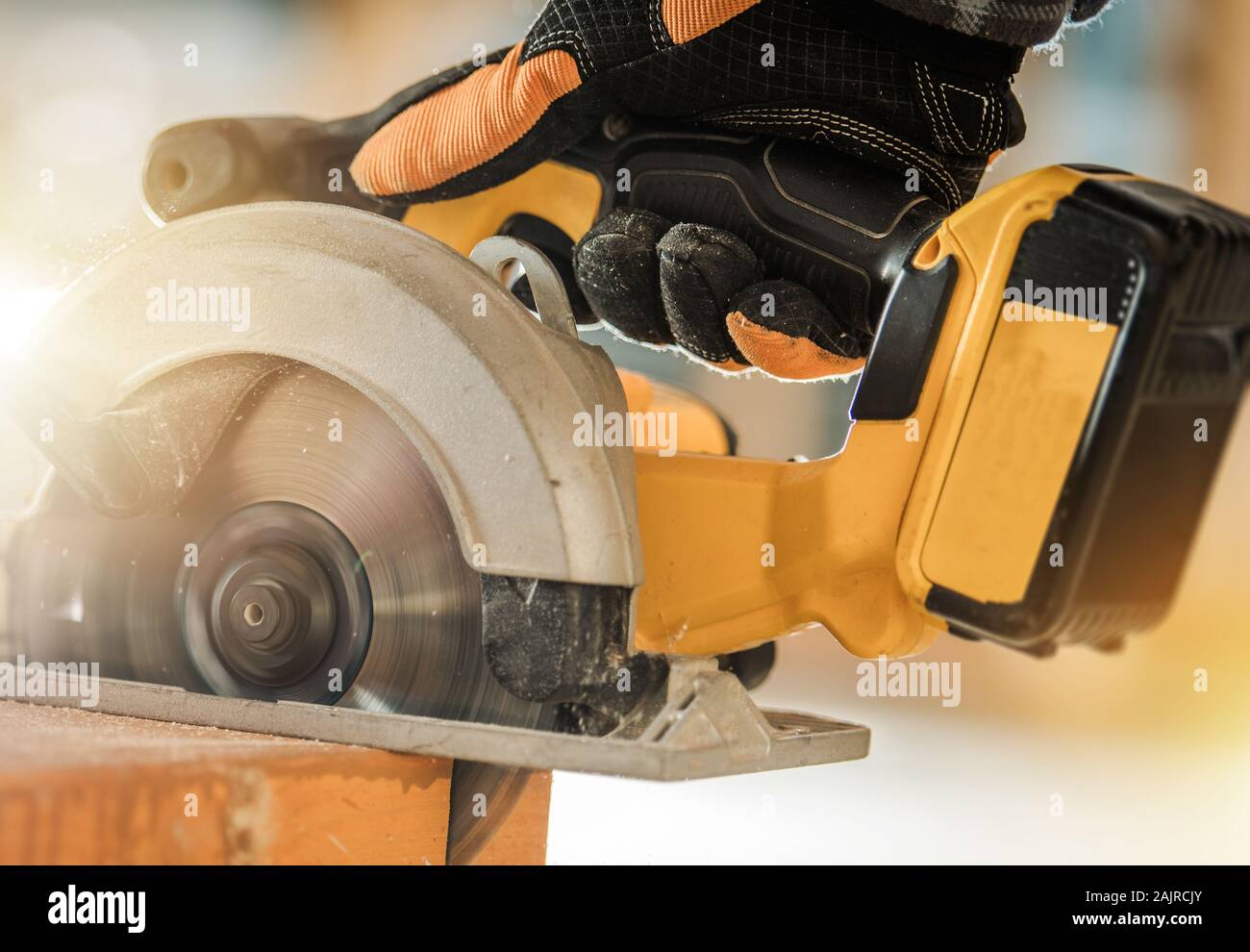 Power Tool in Action. Construction Contractor Cutting Wood Beams Using ...