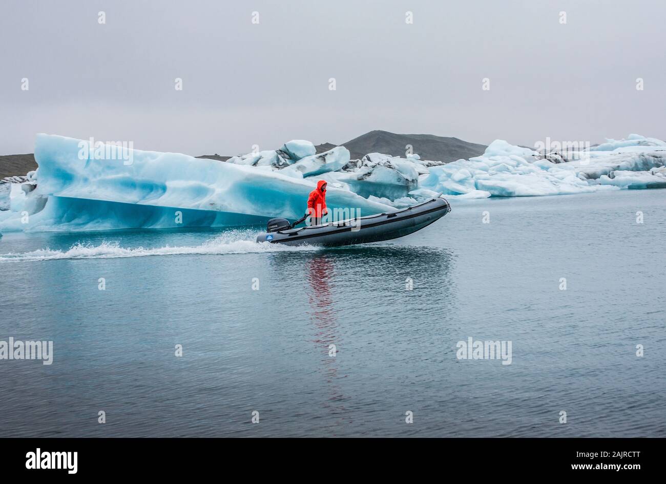 Man on a motorized Zodiac boat, pontoon raft in Iceland Jokulsarlon ...