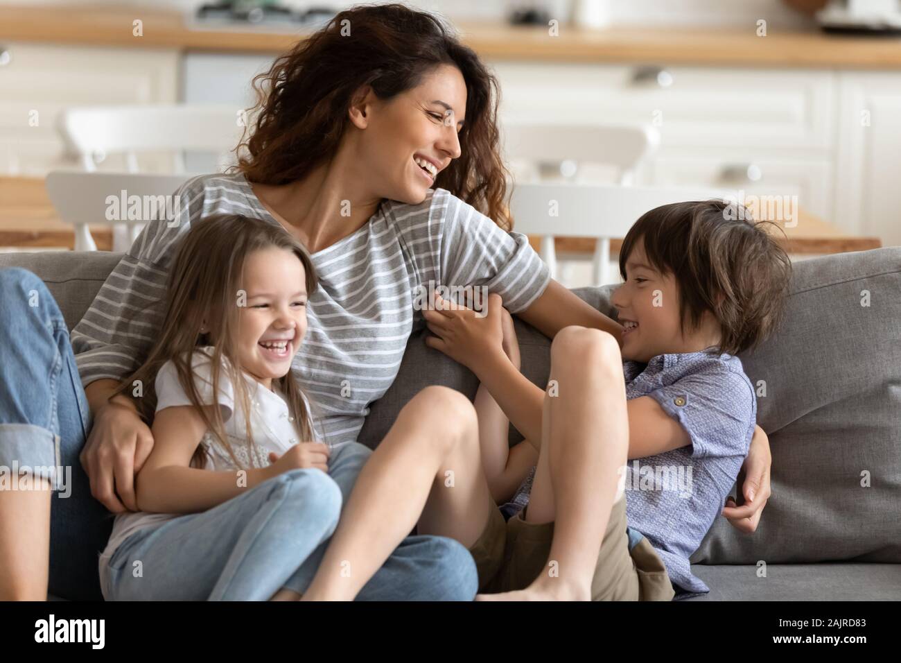 Young mother and little kids playing having fun at home Stock Photo - Alamy