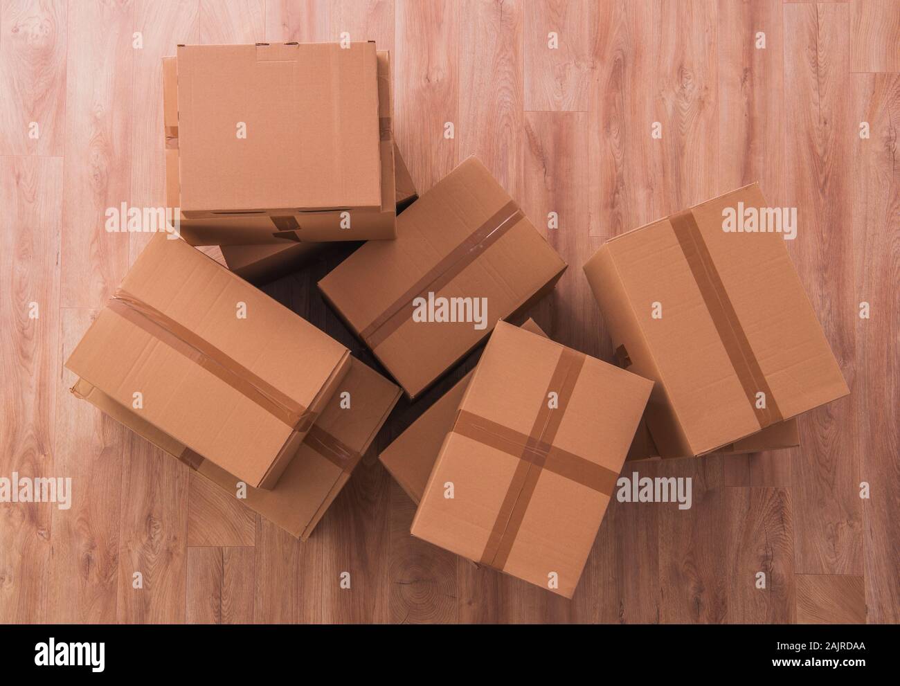 Moving Boxes on Empty Wooden Flooring. Top View Stock Photo - Alamy