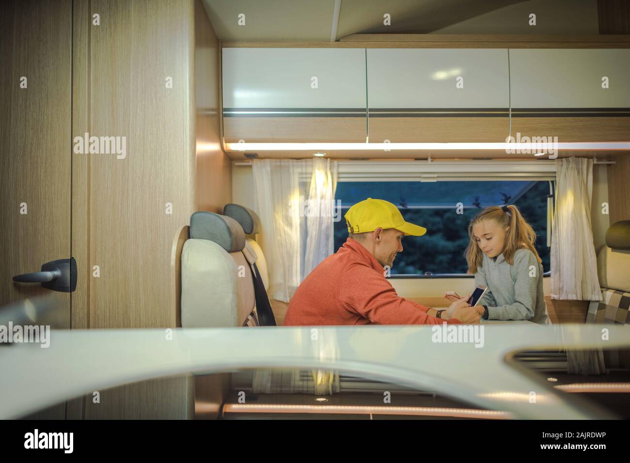 Family Time in RV Recreational Vehicle. Caucasian Men with His Daughter ...