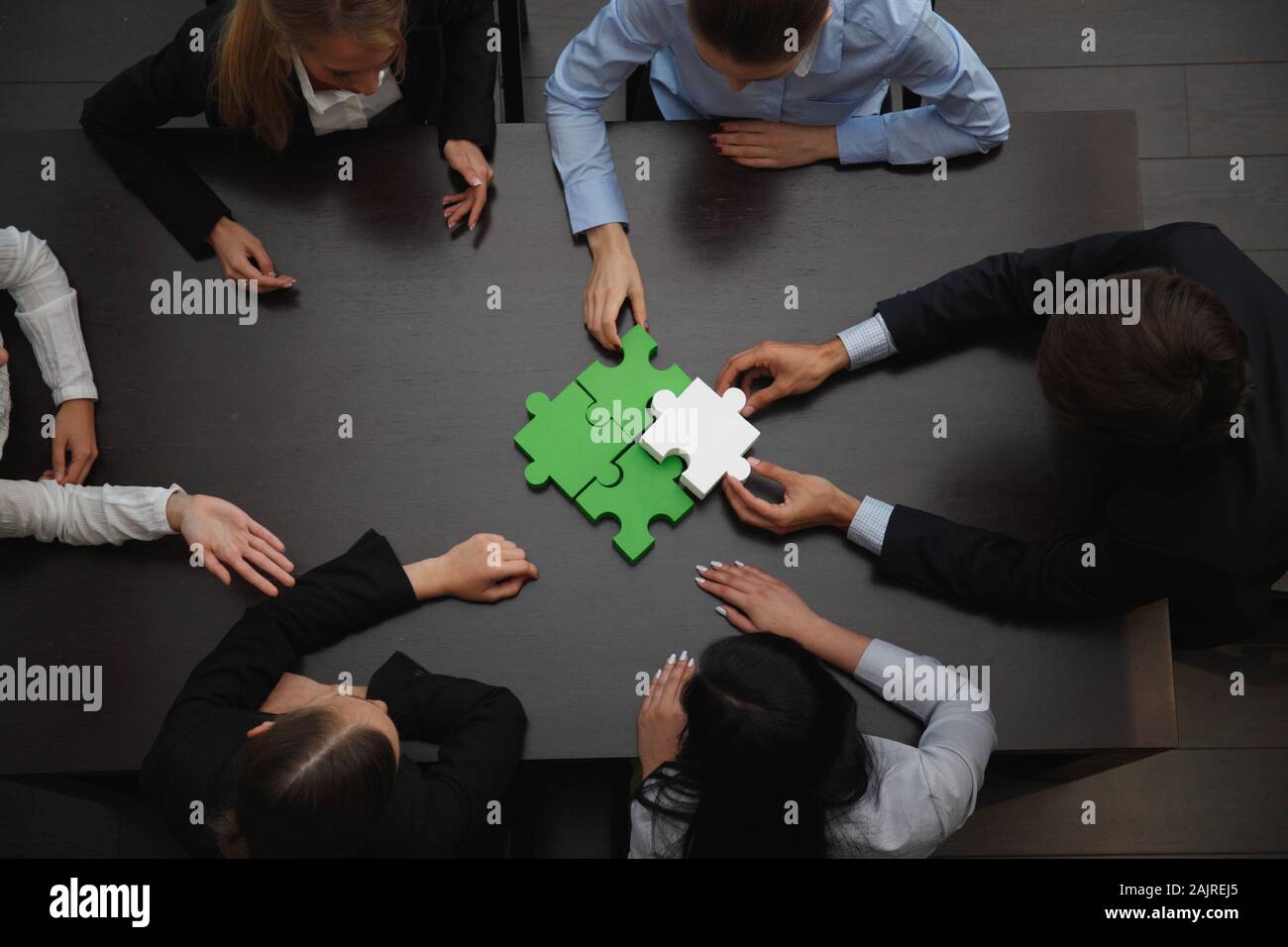 Group of business people assembling jigsaw puzzle, team support and ...