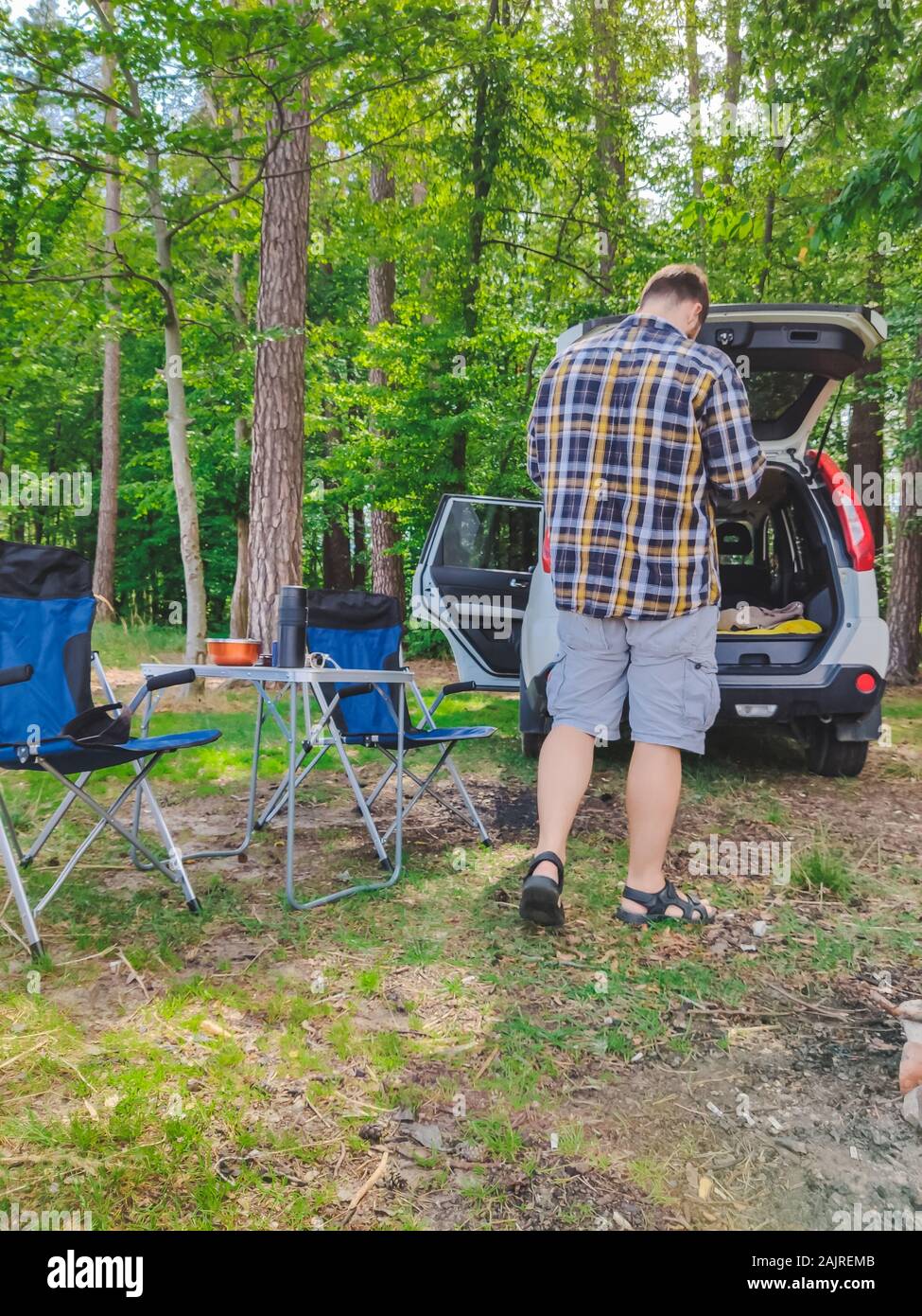 man walking to suv car camping concept Stock Photo - Alamy