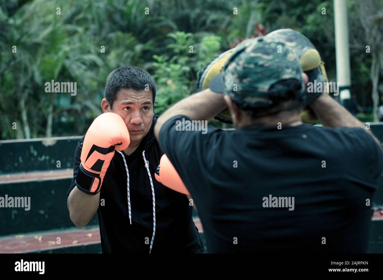 boxing outdoor workout with trainer, punching exercises with personal ...