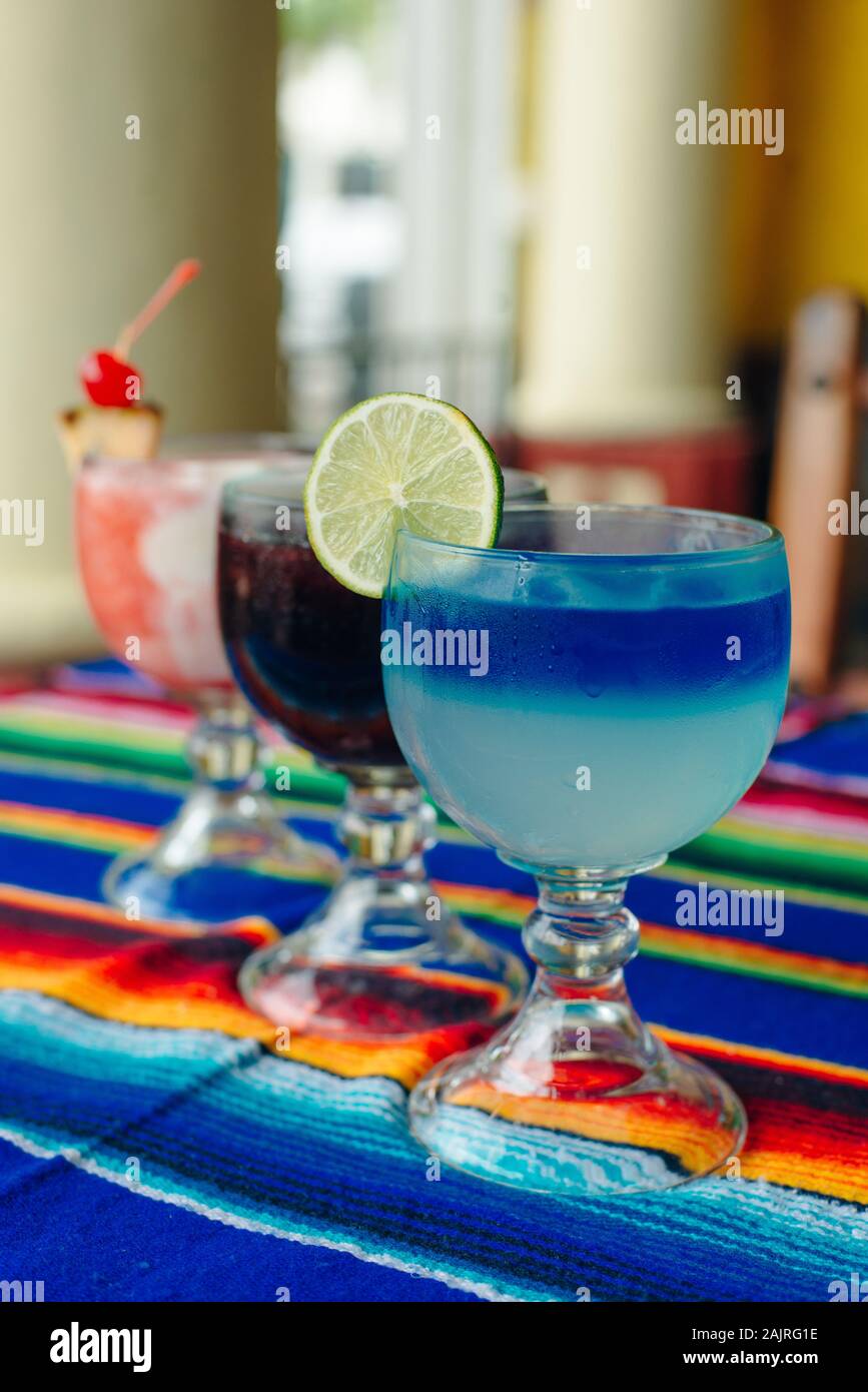 multi-colored cocktails in large glasses in restaurant Mexico Stock ...