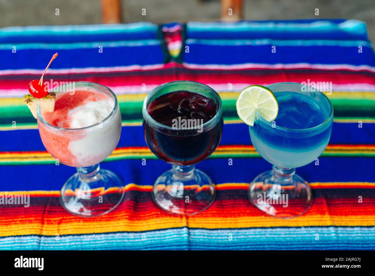 multi-colored cocktails in large glasses in restaurant Mexico Stock ...