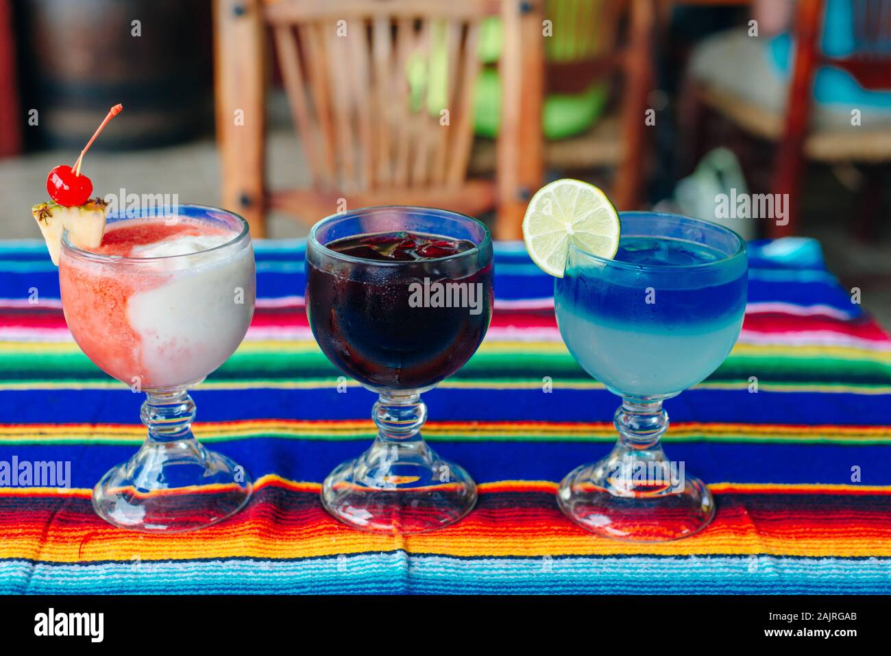 multi-colored cocktails in large glasses in restaurant Mexico Stock ...