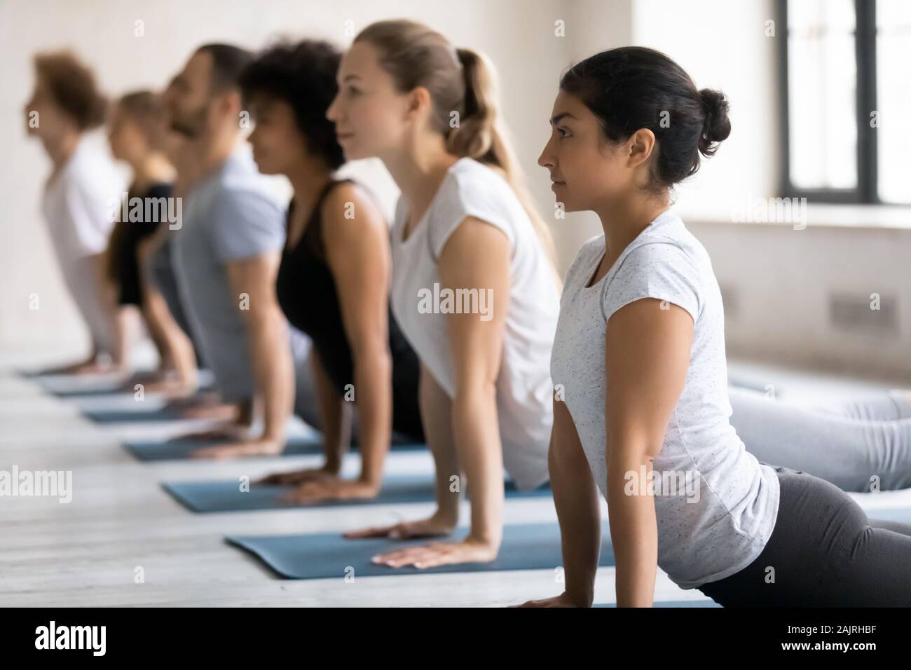 Diverse people doing upward facing dog exercise, practicing yoga Stock ...