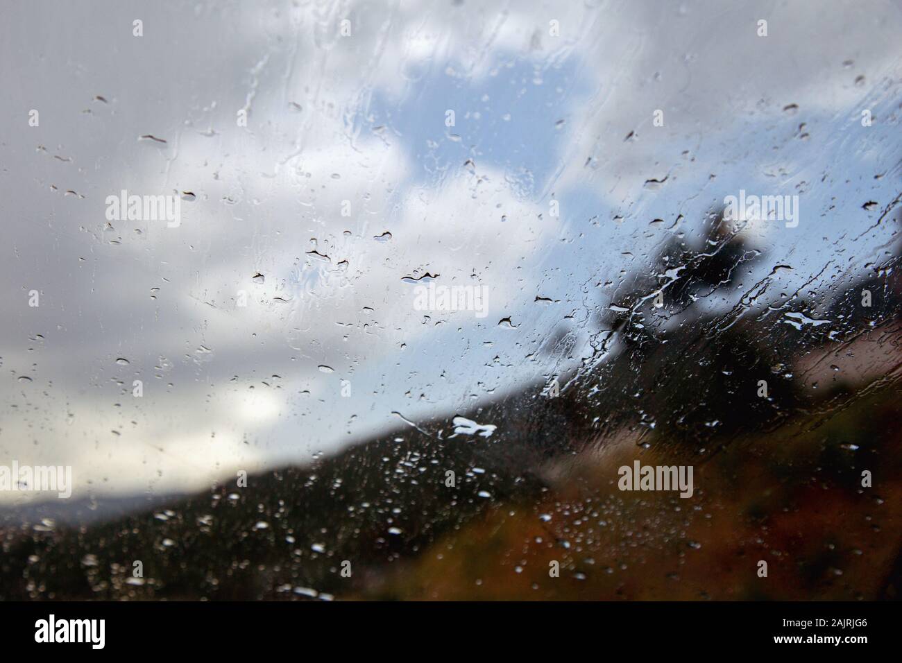 Car window with rain drops. Driving in rain. Weather background. Rainy ...