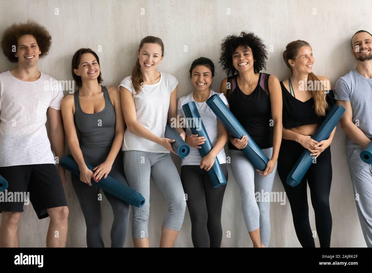Group of happy diverse people with yoga mats posing together Stock ...